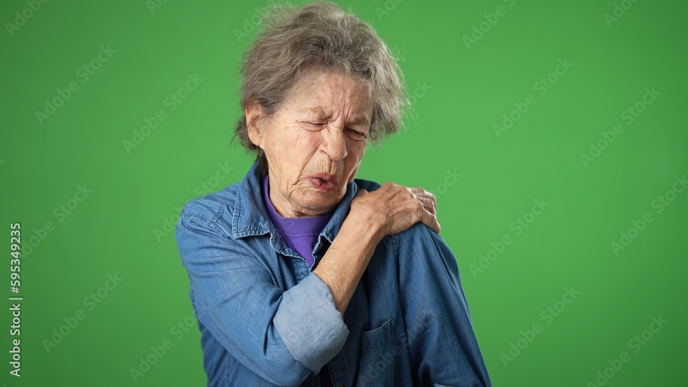 Portrait of elderly mature old woman with health problem shoulder pain ...