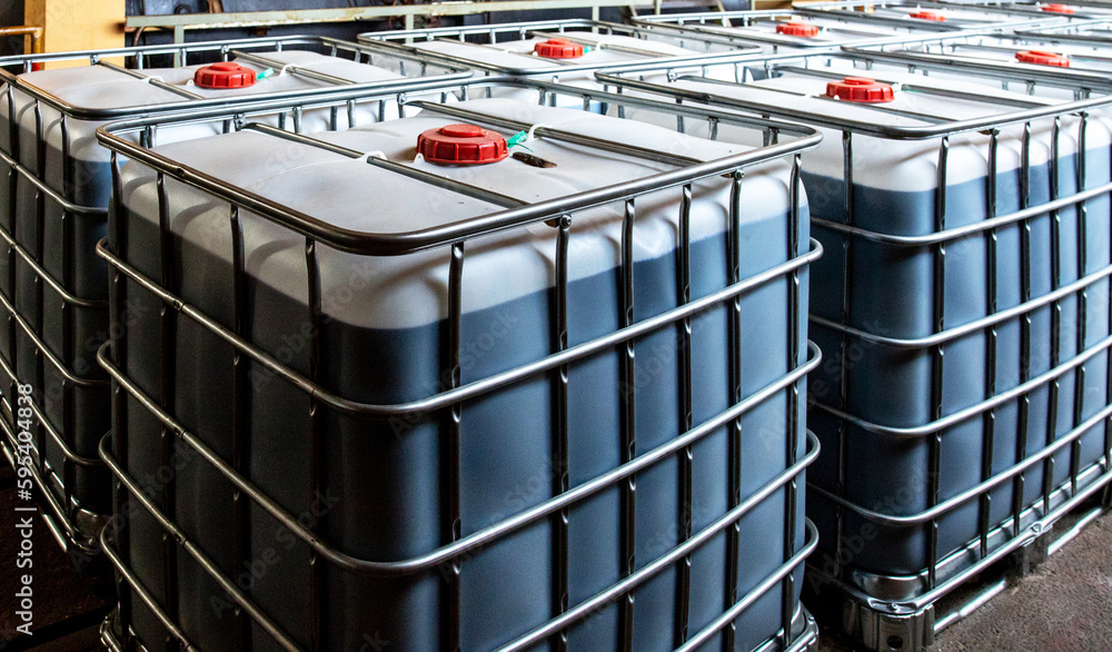 large plastic containers with liquids in production. Barrels for the ...