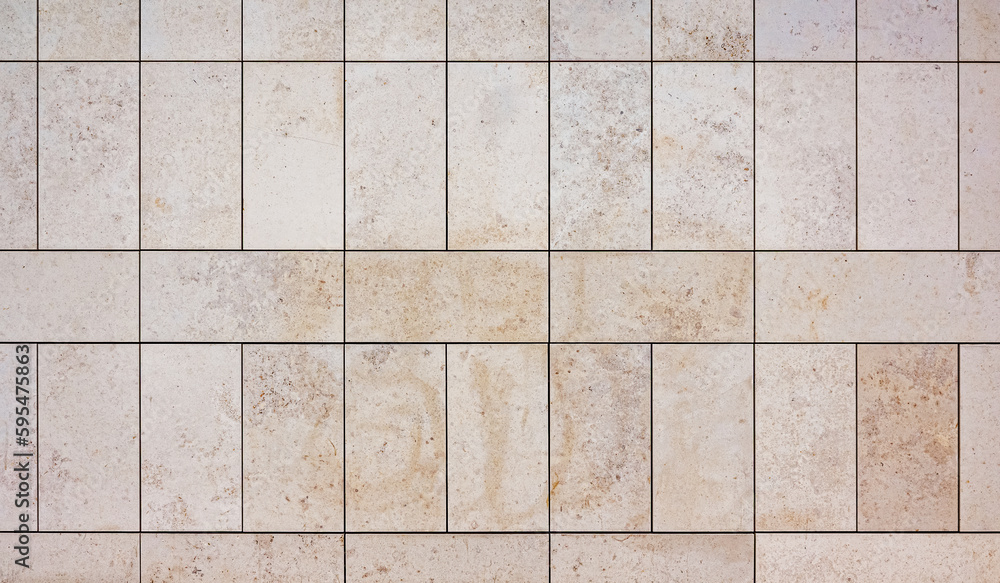 texture of a tiled beige stone wall as background, natural stone wall ...
