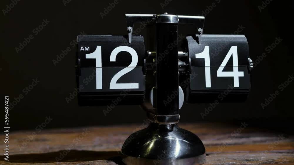 Vintage flip clocks on dark black backgrounds on wood desk timelapse ...