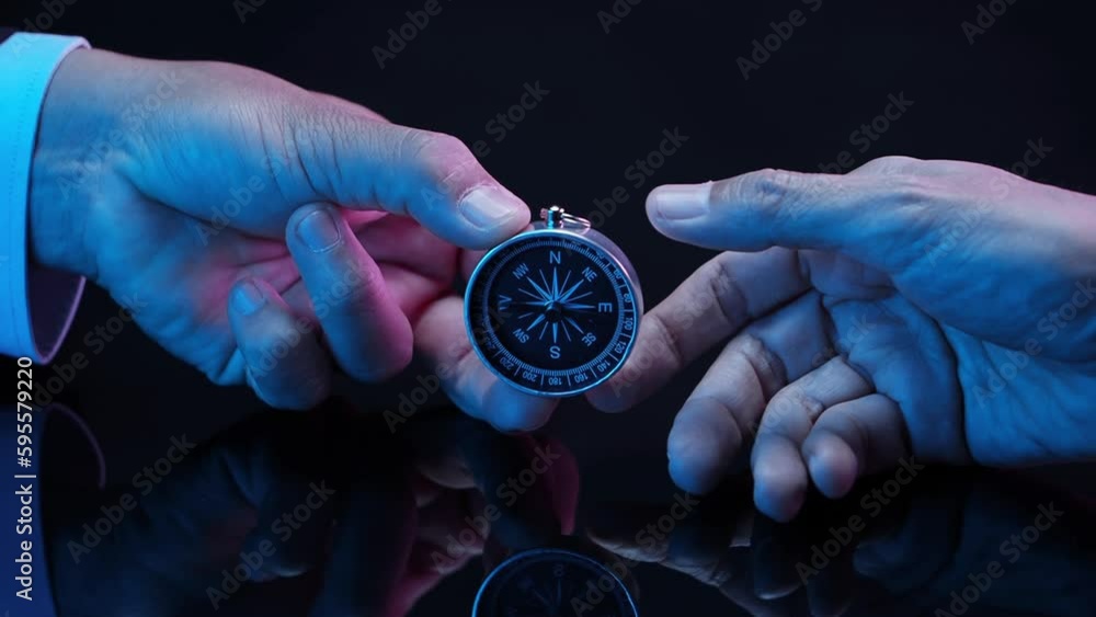 A navigation compass in hand with virtual of gear icon present ...