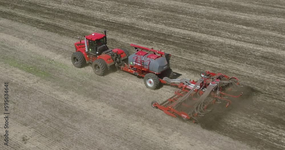 Field works. Tractor sowing seeds with seeder driller in field. Process ...