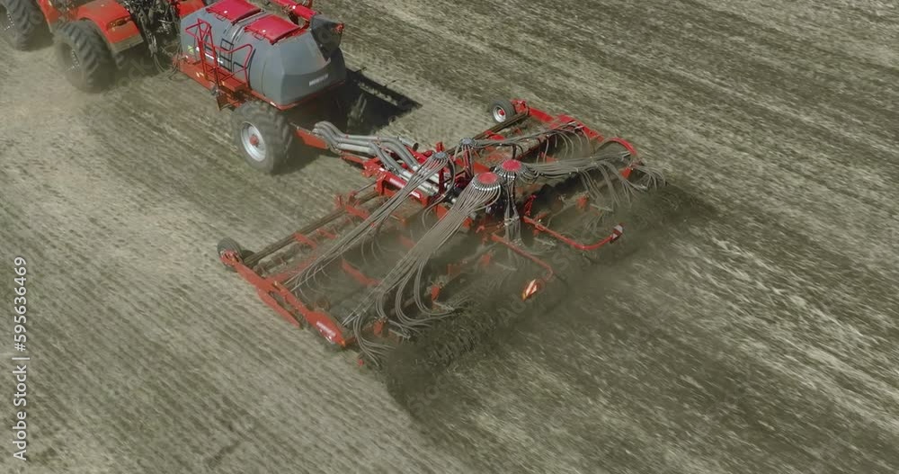 Field works. Tractor sowing seeds with seeder driller in field. Process ...