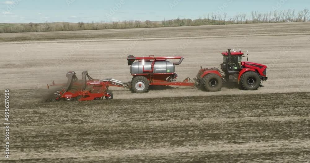 Field works. Tractor sowing seeds with seeder driller in field. Process ...