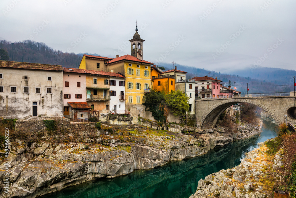 Beautiful ancient mediterranean town with stone arch bridge and emerald ...