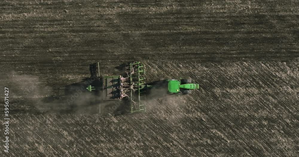 Field works. Tractor sowing seeds with seeder driller in field. Process ...
