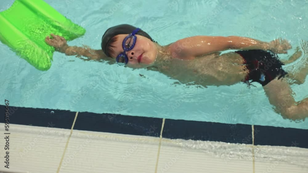 swimming pool training lesson for kids. little boy child learning to ...