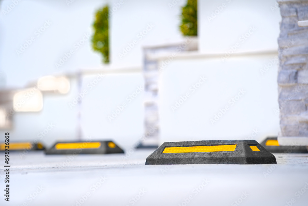 Rubber limiter yellow stripe parking space separators near hotel ...