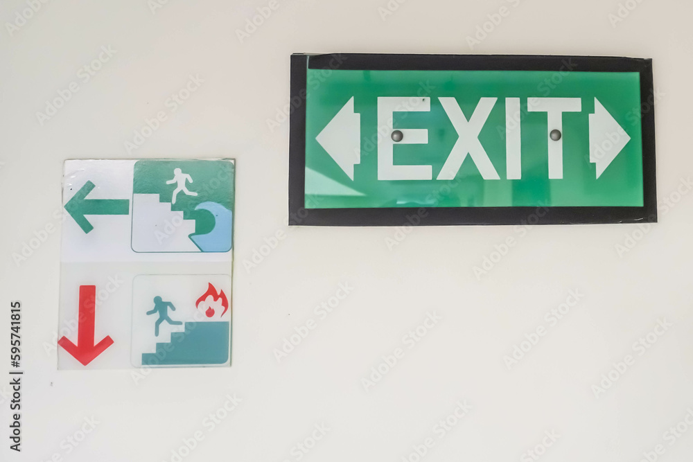 Fire and flood exit sign in the corridor of the building with arrow ...