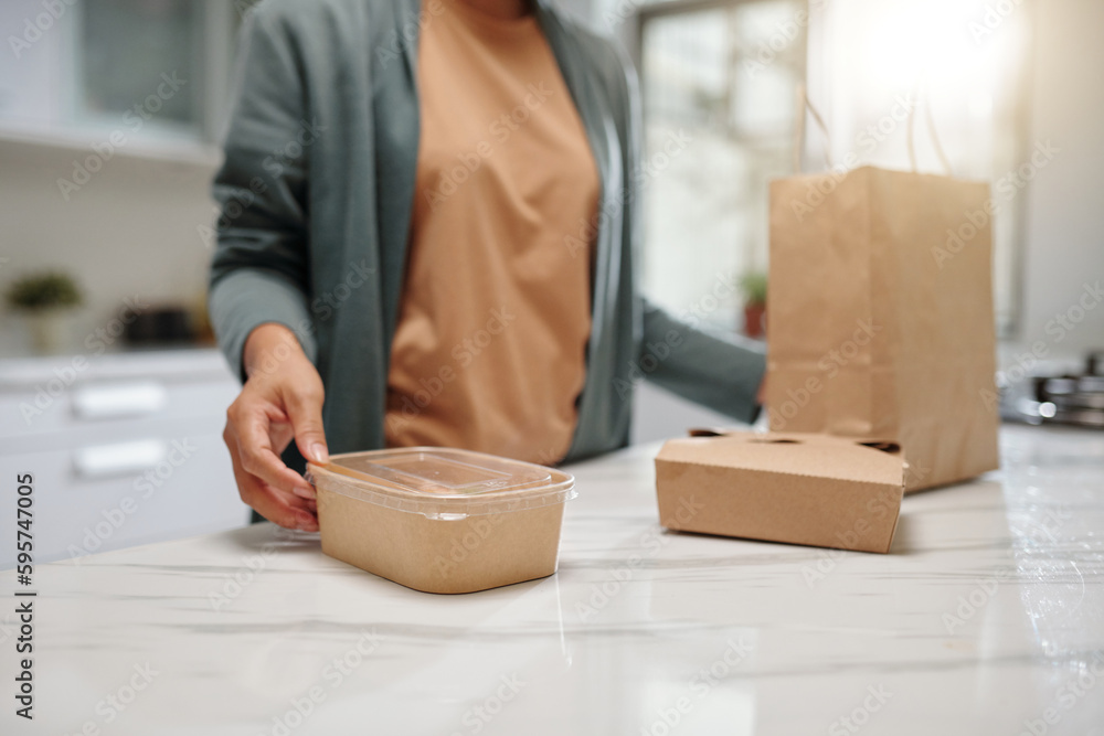 Woman taking containers with dishes out of paper package Stock Photo ...