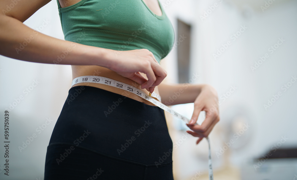 Asian woman with anorexia with measuring tape feeling unhappy. Anorexia ...