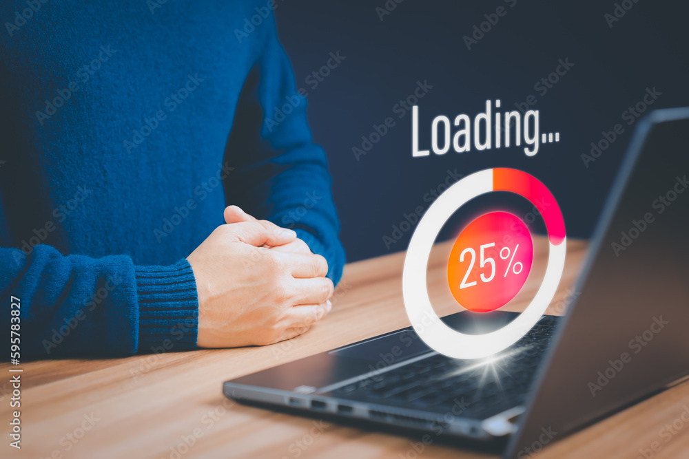 Concept of waiting for load of loading symbol. Young man using a laptop ...