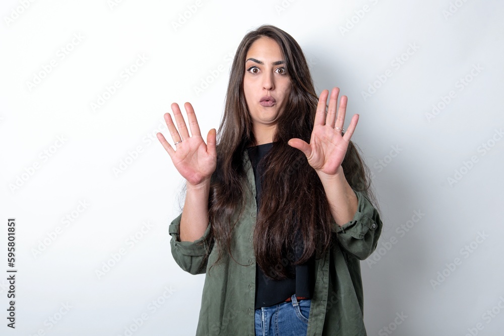 young brunette woman wearing casual clothes over white studio ...