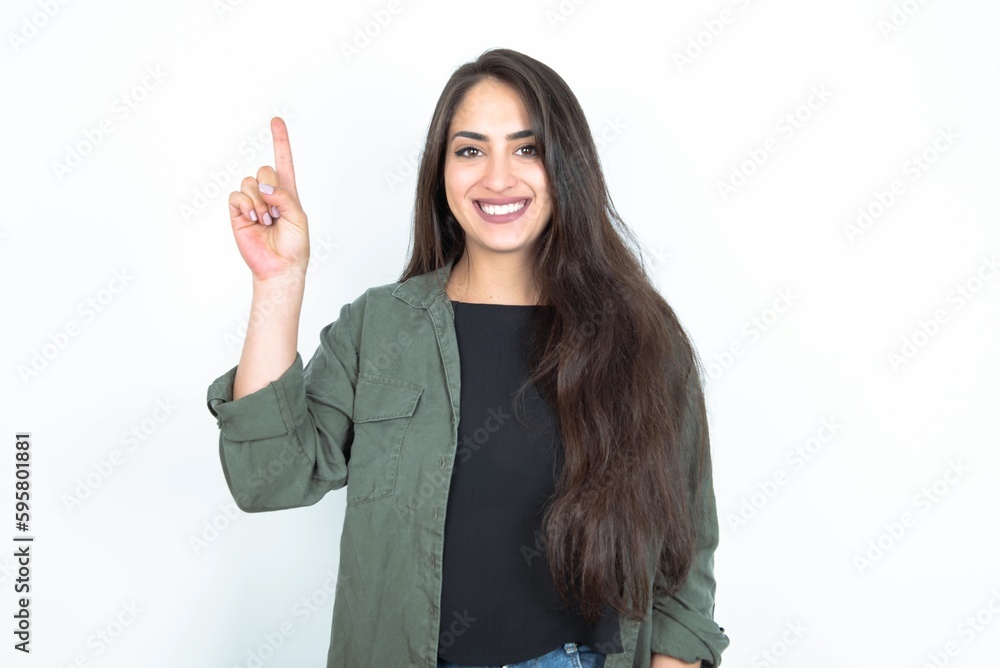 young brunette woman wearing casual clothes over white studio ...