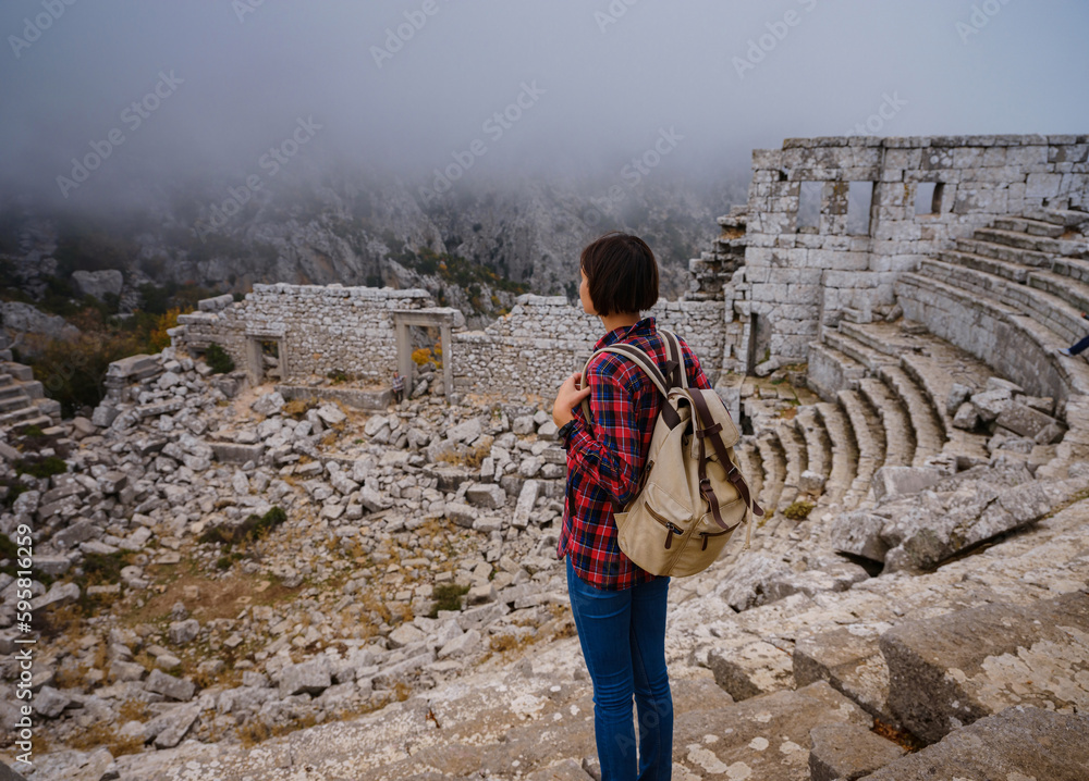 Autumn walk , woman looking at the ancient amphitheatre in city ...