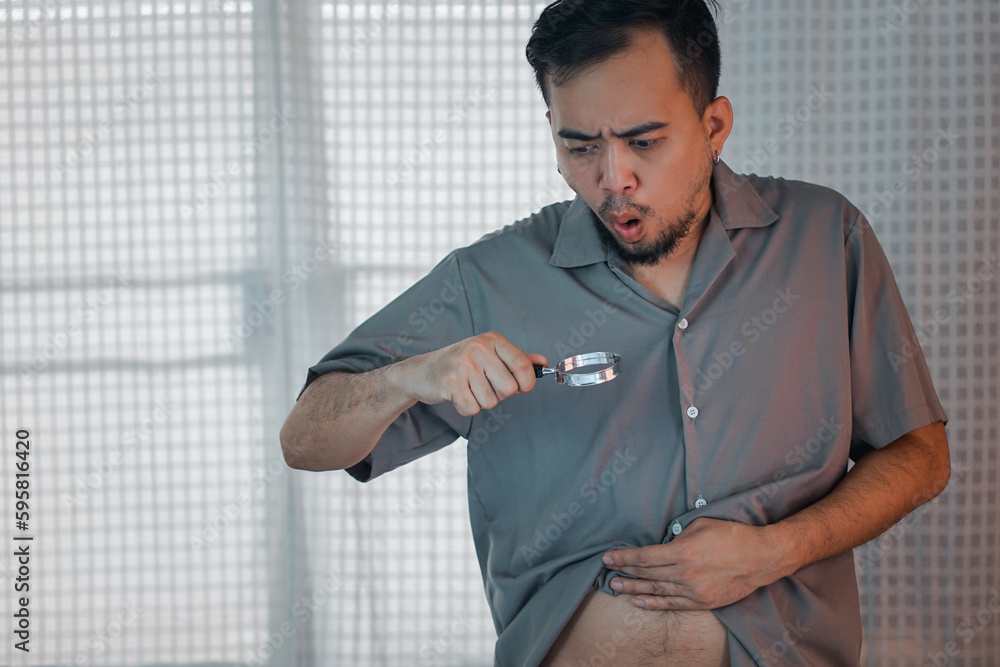 magnifying glass looks at man's crotch. Examination of the male ...