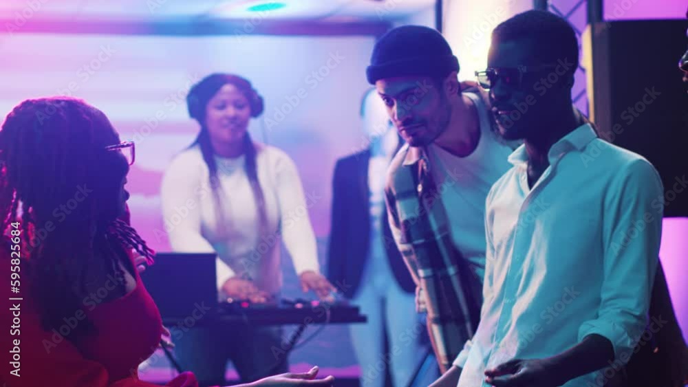 Diverse people having fun at party, dancing and jumping together at ...