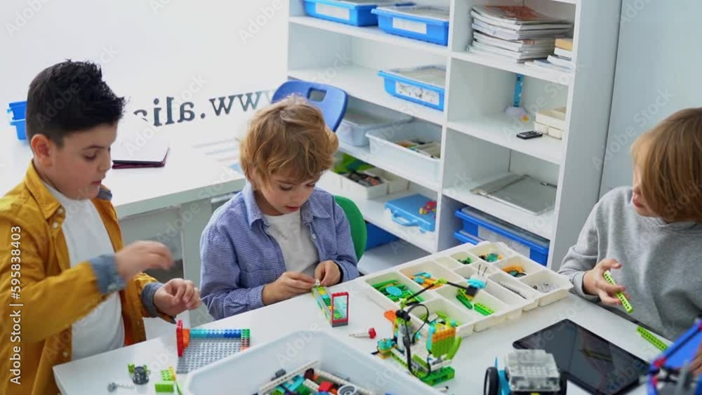 Robotics programming class. Children construct and code Robot. STEM ...