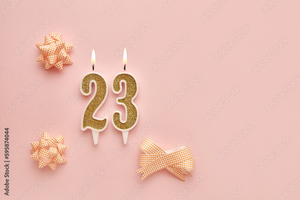 Number 23 on a pastel pink background with festive decorations. Happy ...