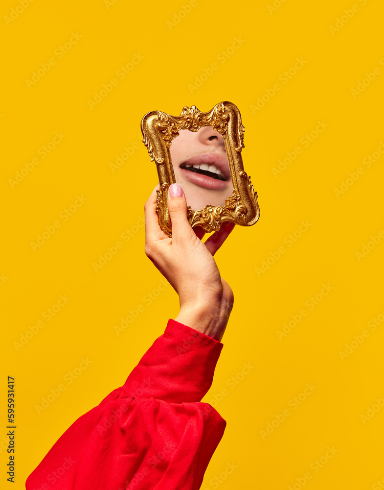 Female hand holding small mirror with reflection of beautiful woman's ...