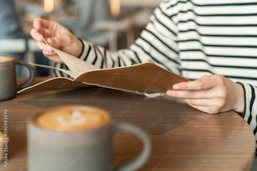 Person reading menu in restaurant. Guest of cafe or restaurant reading ...