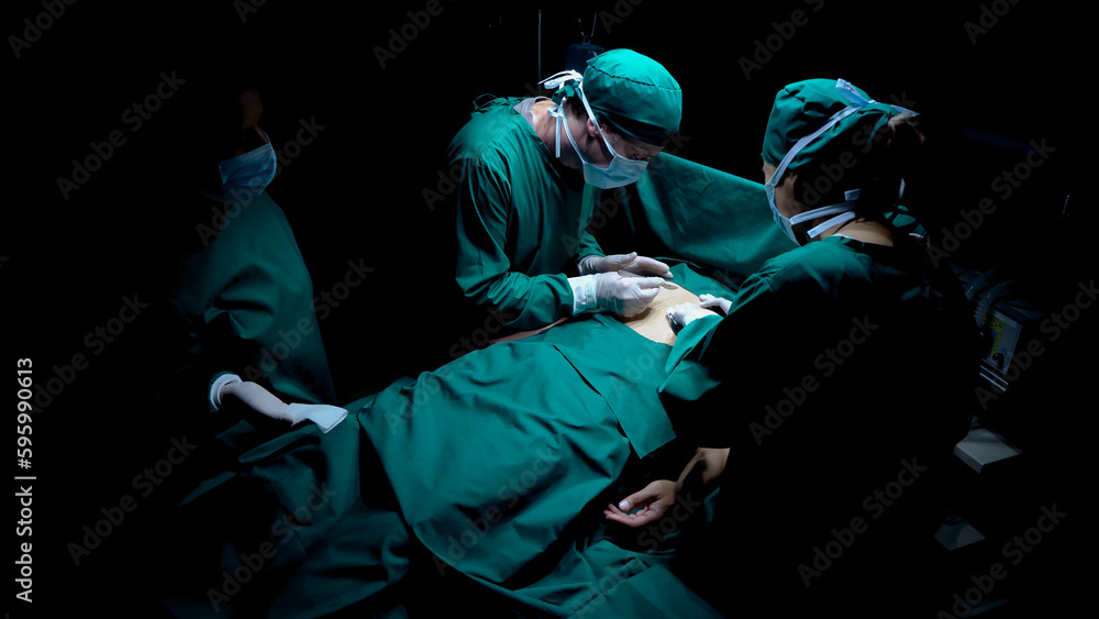 Doctor is doing an operation on patient in operating room lying on ...