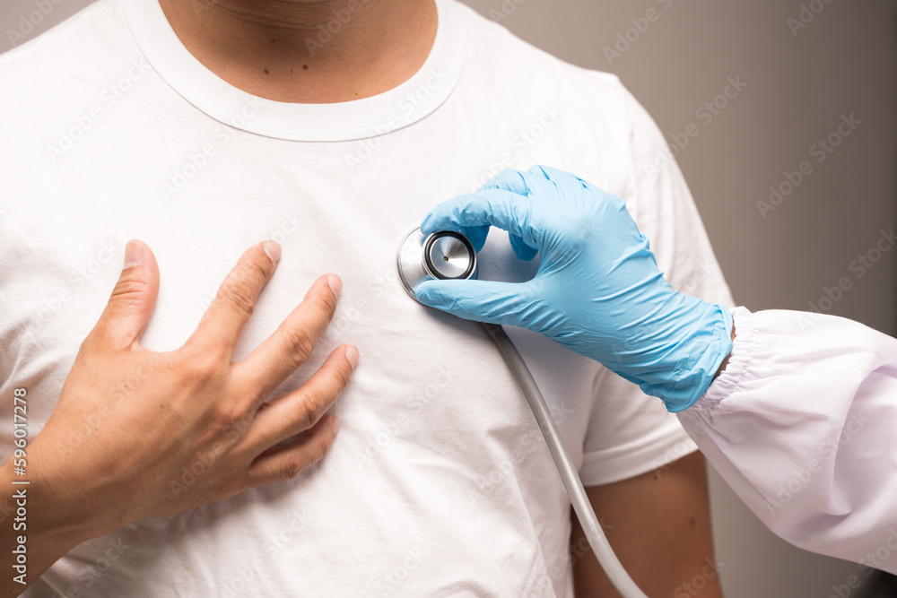 Woman doctor hold stethoscope exam young man patient visit doctor with ...
