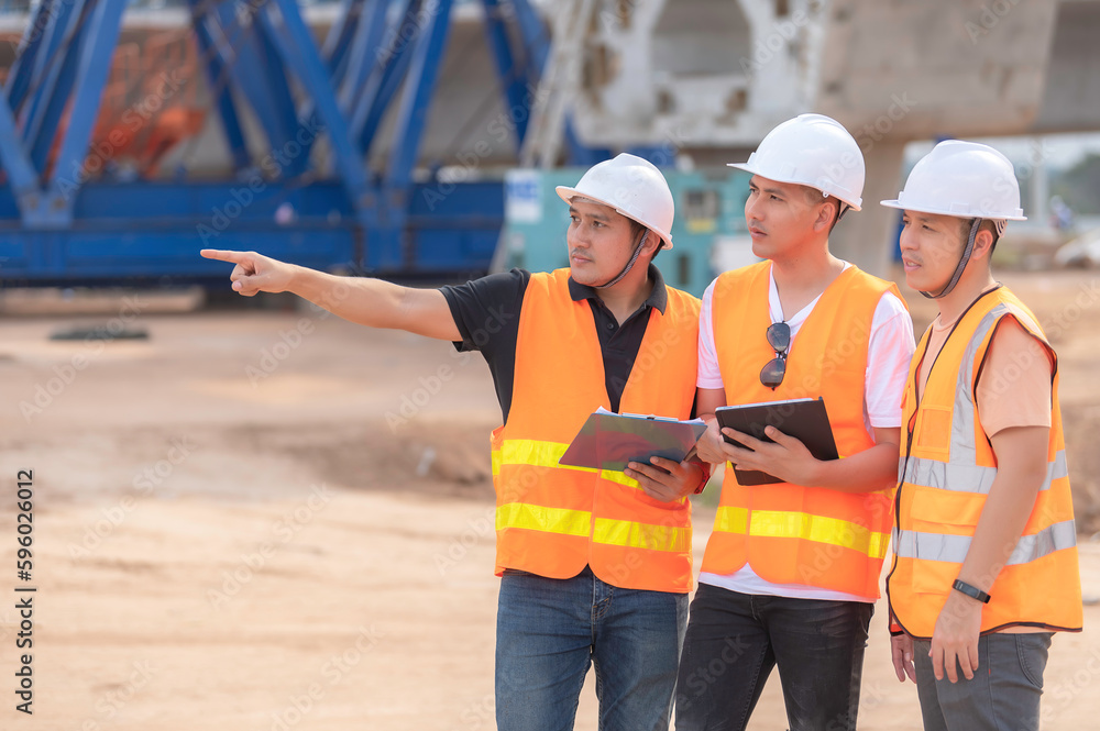 Group of asian engineers discuss about work at site of building under ...