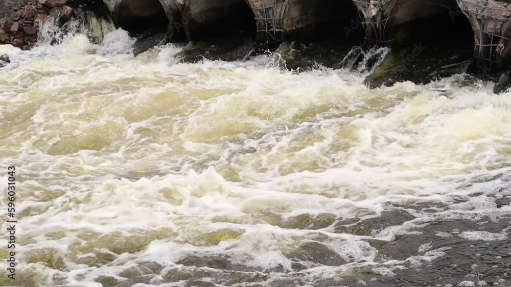 A concrete pipe that carries smelly, polluted sewage into the river ...