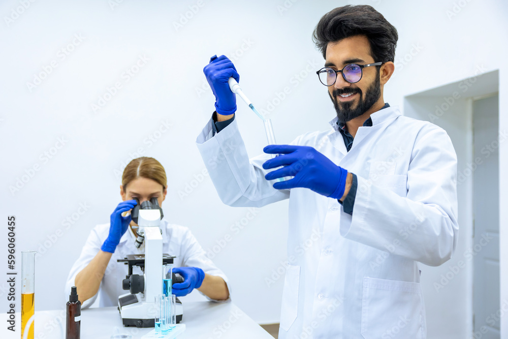 Scientists using pipette test tube in science laboratory, examine ...