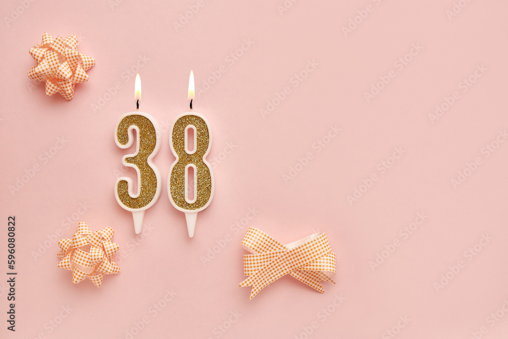 Number 38 on a pastel pink background with festive decorations. Happy ...