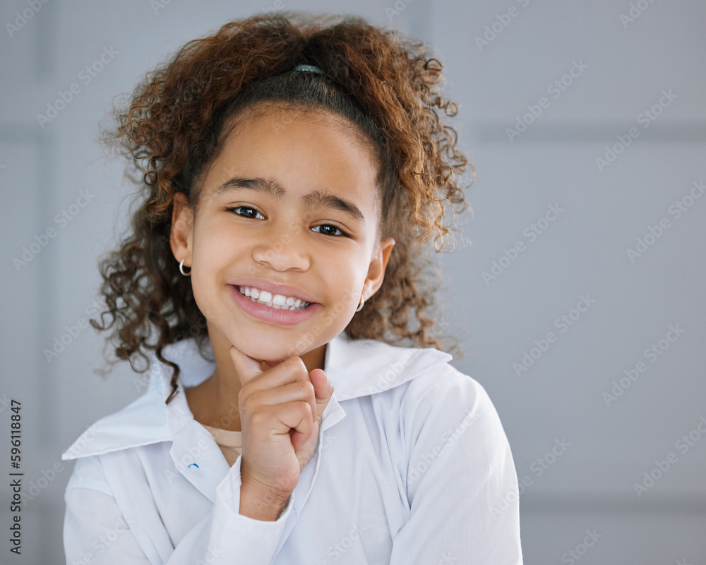 Mmm... I wonder. Cropped portrait of an adorable little girl standing ...
