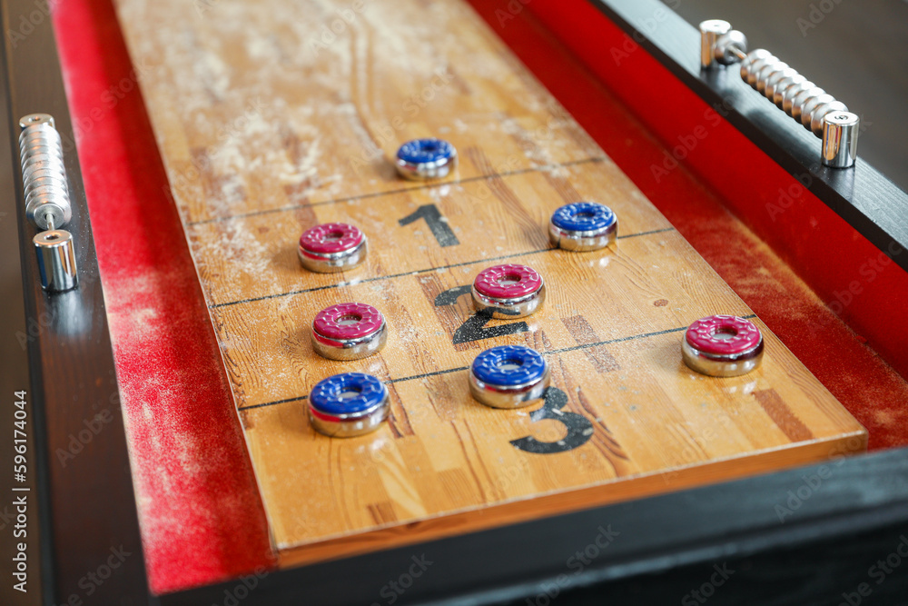 Shuffleboard is a game of precision and strategy, where players slide ...