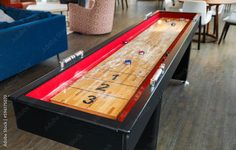 Shuffleboard is a game of precision and strategy, where players slide ...