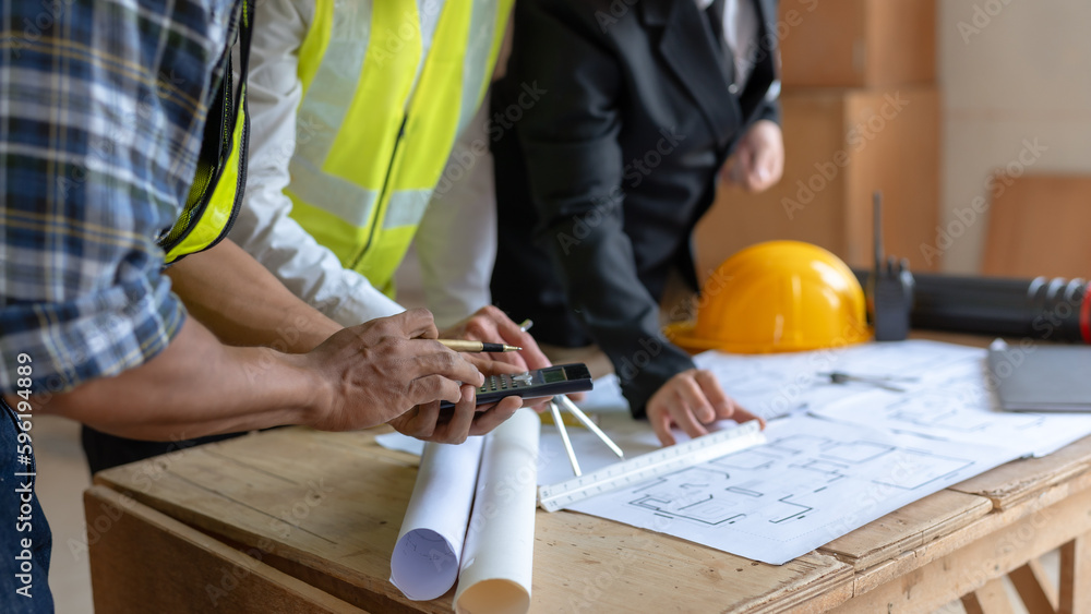 Architect or engineer are designing house, modifying plan, creating ...