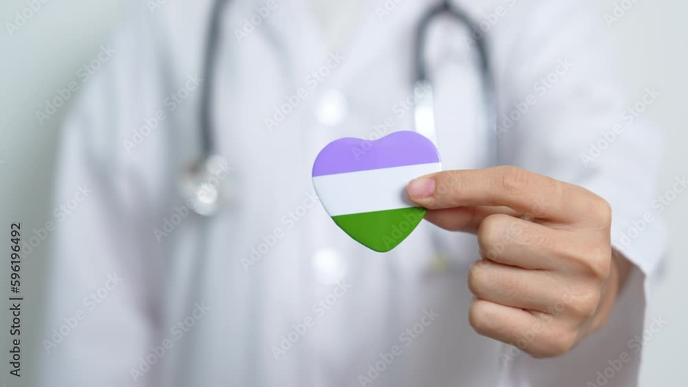 Queer Pride Day and LGBT pride month concept. Doctor hand holding ...