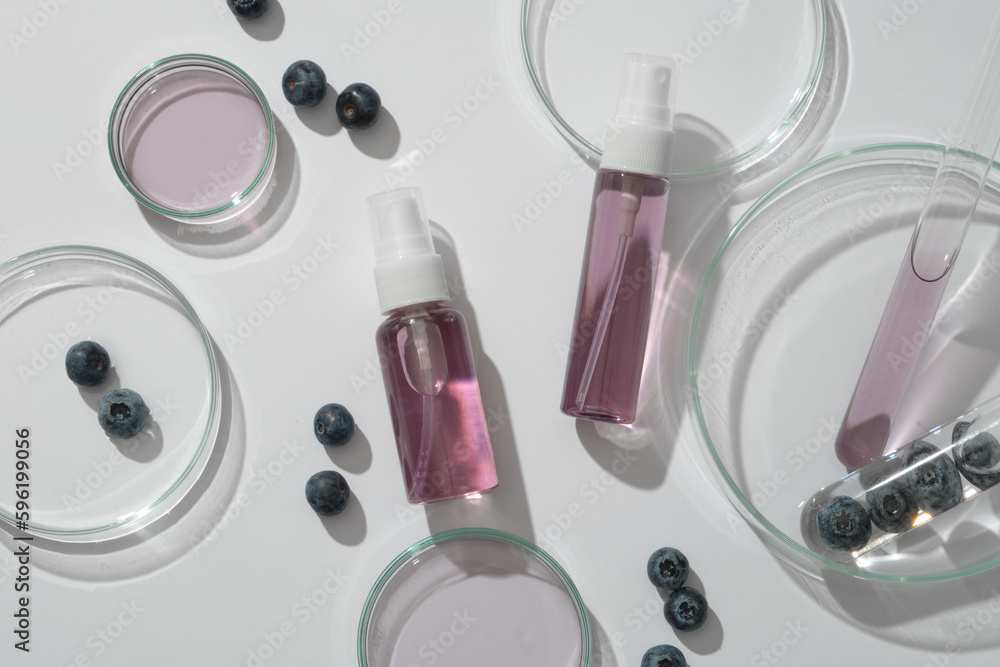 Mockup scene for cosmetic with two bottle unlabeled, blueberries and ...