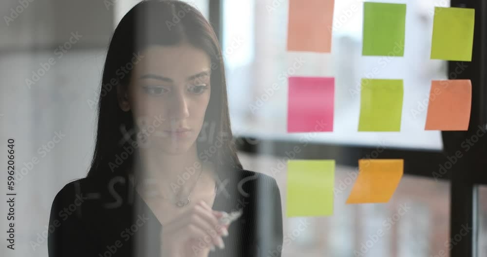 Vidéo Stock Attractive female manager writes down information and ...