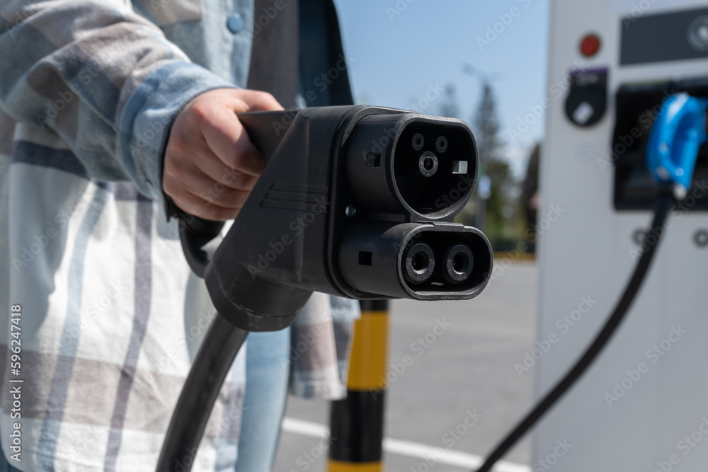 Woman holding CCS fast charging socket type 2. Combined Charging System ...