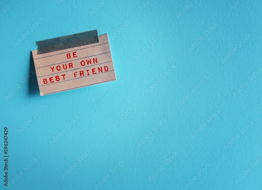 Stick note on blue copy space background with handwritten text BE YOUR ...