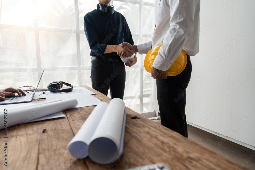 Professional Asian male engineer shaking hands with architect after ...