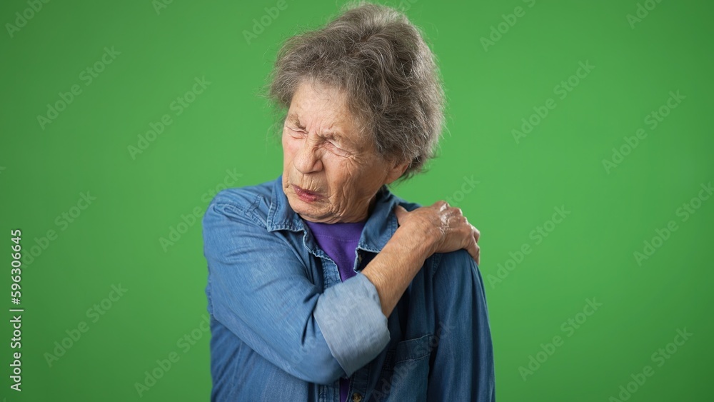 Portrait of elderly mature old woman with health problem shoulder pain ...