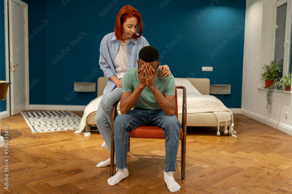 Unhappy diverse couple discussing divorce at home, husband feeling sad ...