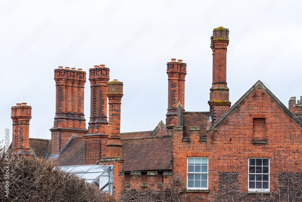 HAMPTON COURT, UK: 2013 CIRCA MARCH 2023: Chimney stacks above rooms at ...