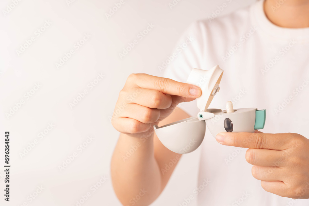 Prepare asthma inhaler for use. Woman hands put Tiotropium bromide ...