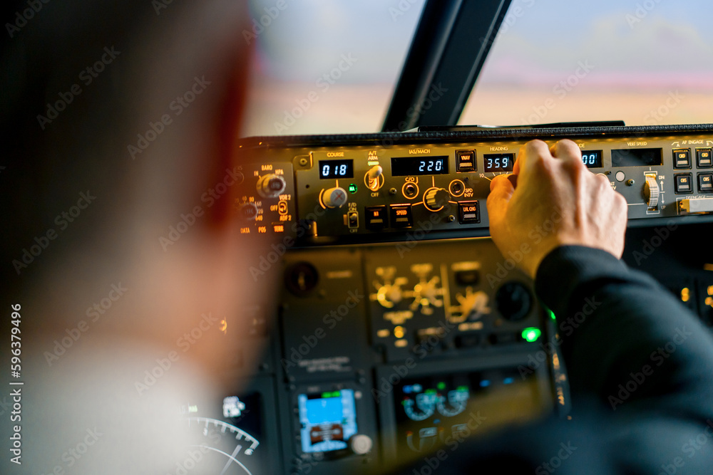 Airplane cockpit View from behind the pilot's shoulder Pressing buttons ...