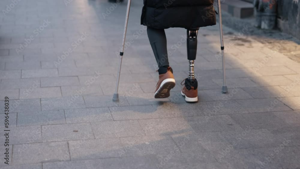 walking down, leg amputation, adaptive living. Young man prosthetic leg ...