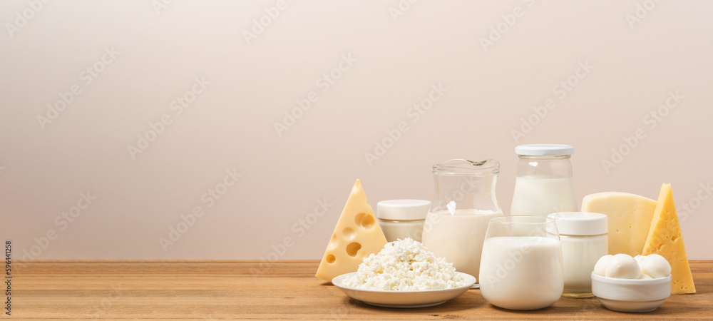 Variation of organic dairy products on wooden table. Farm cheeses, milk ...
