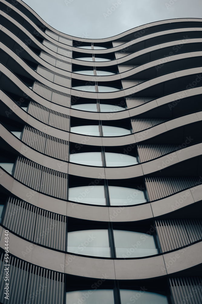 Curved skyscraper building with balconies, tall high rise buildings ...