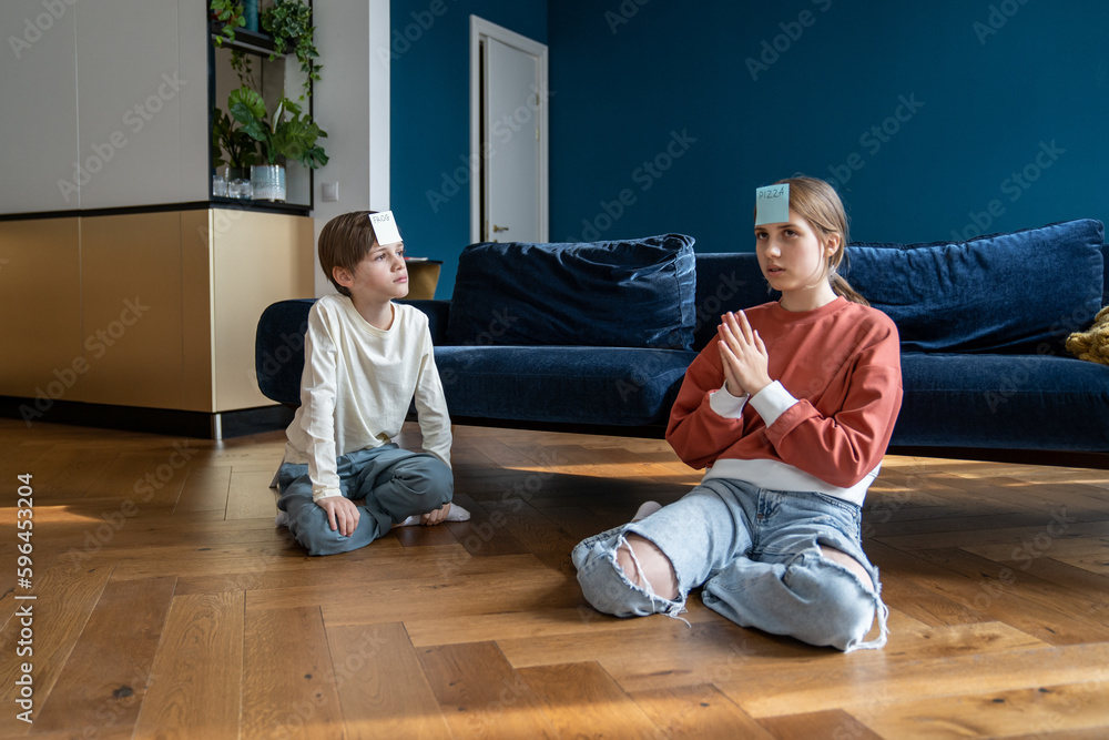 Guess who I am. Small children friends playing guessing game with ...